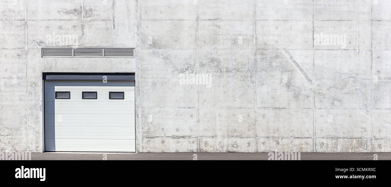 closed automatic roll-up gates on gray concrete textured wall ...