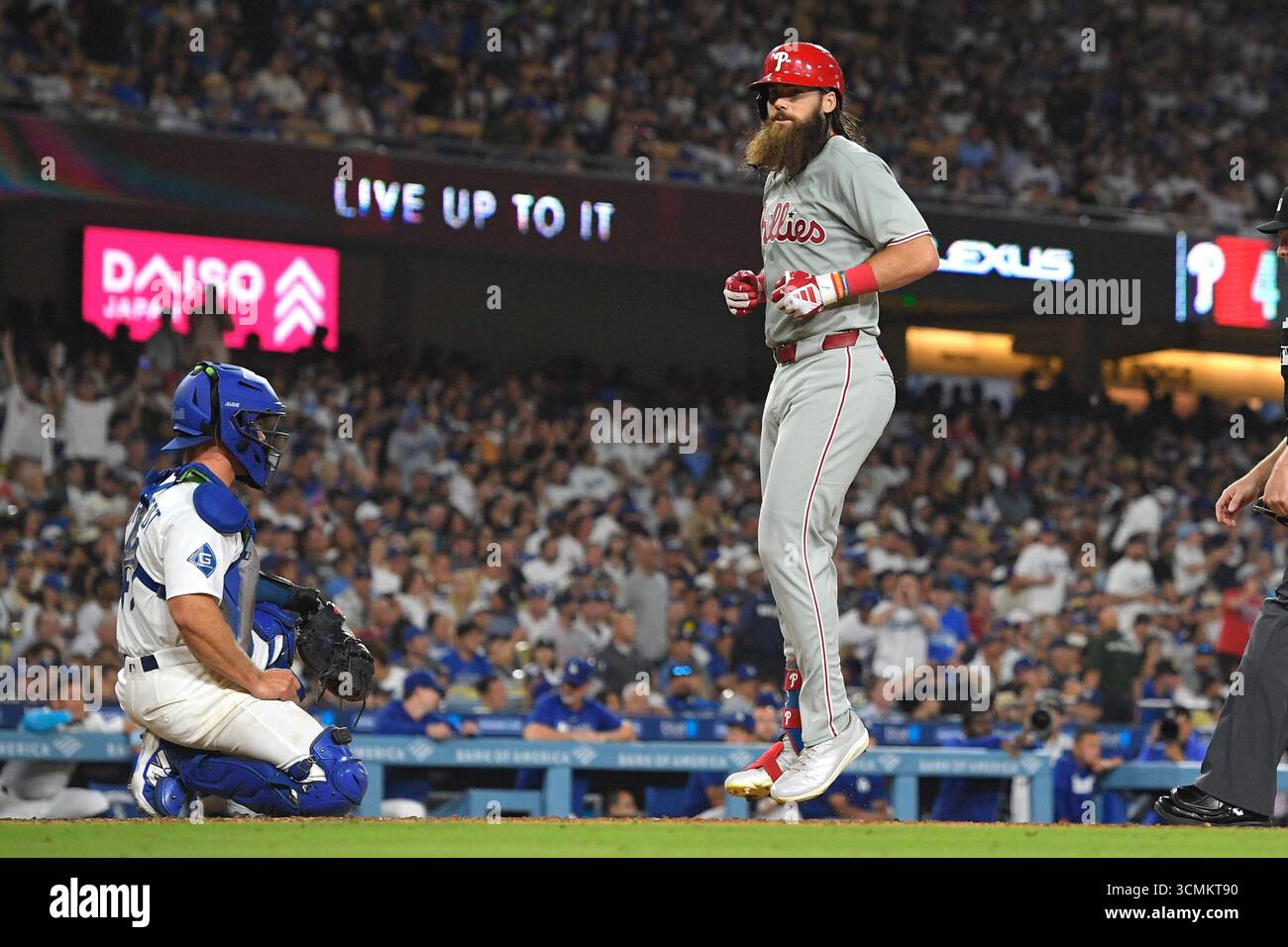 Philadelphia Phillies' Brandon Marsh, right, scores after hitting a ...