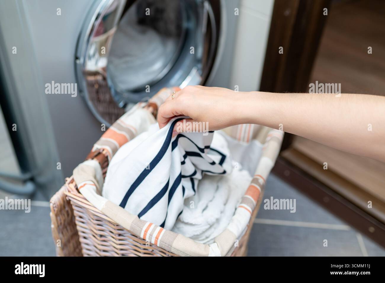 Female hand removing laundry hi-res stock photography and images - Alamy
