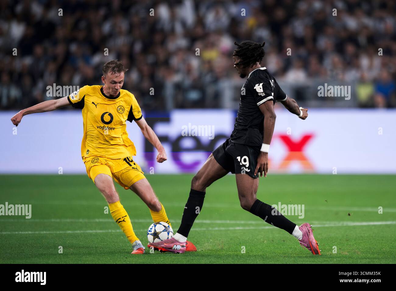 Maximilian Beier of Borussia Dortmund competes for the ball with ...