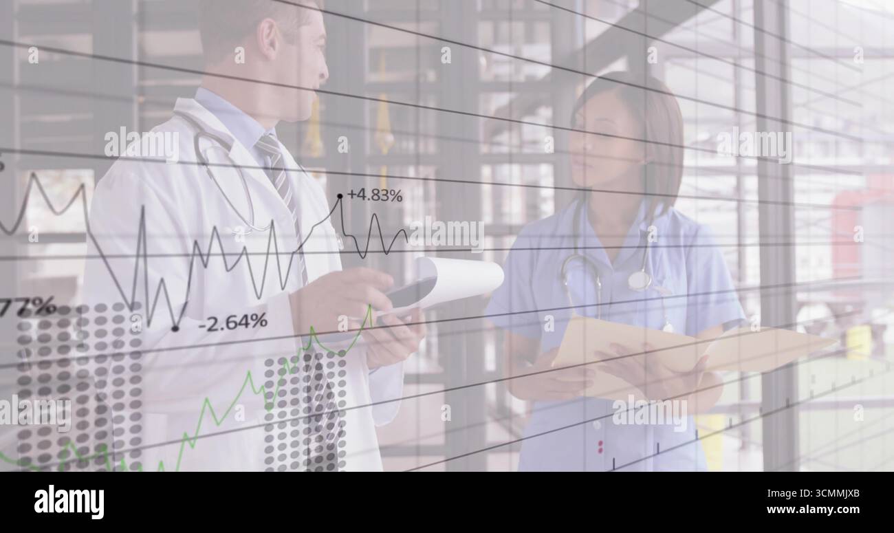Reviewing charts lab coat physician and nurse in scrubs in hospital ...