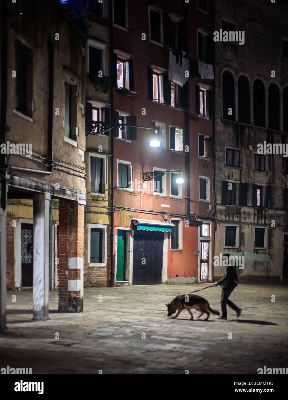 Venice, Italy, Dec 26 2018, A man walks his dog through Campo del ...