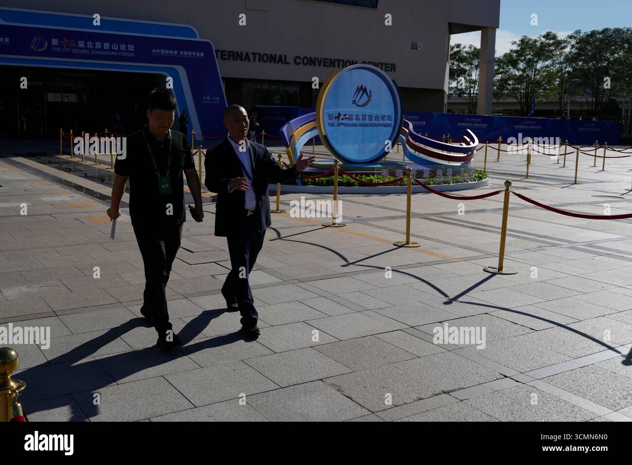 Men past by the venue for China's annual security and defense dialogue ...