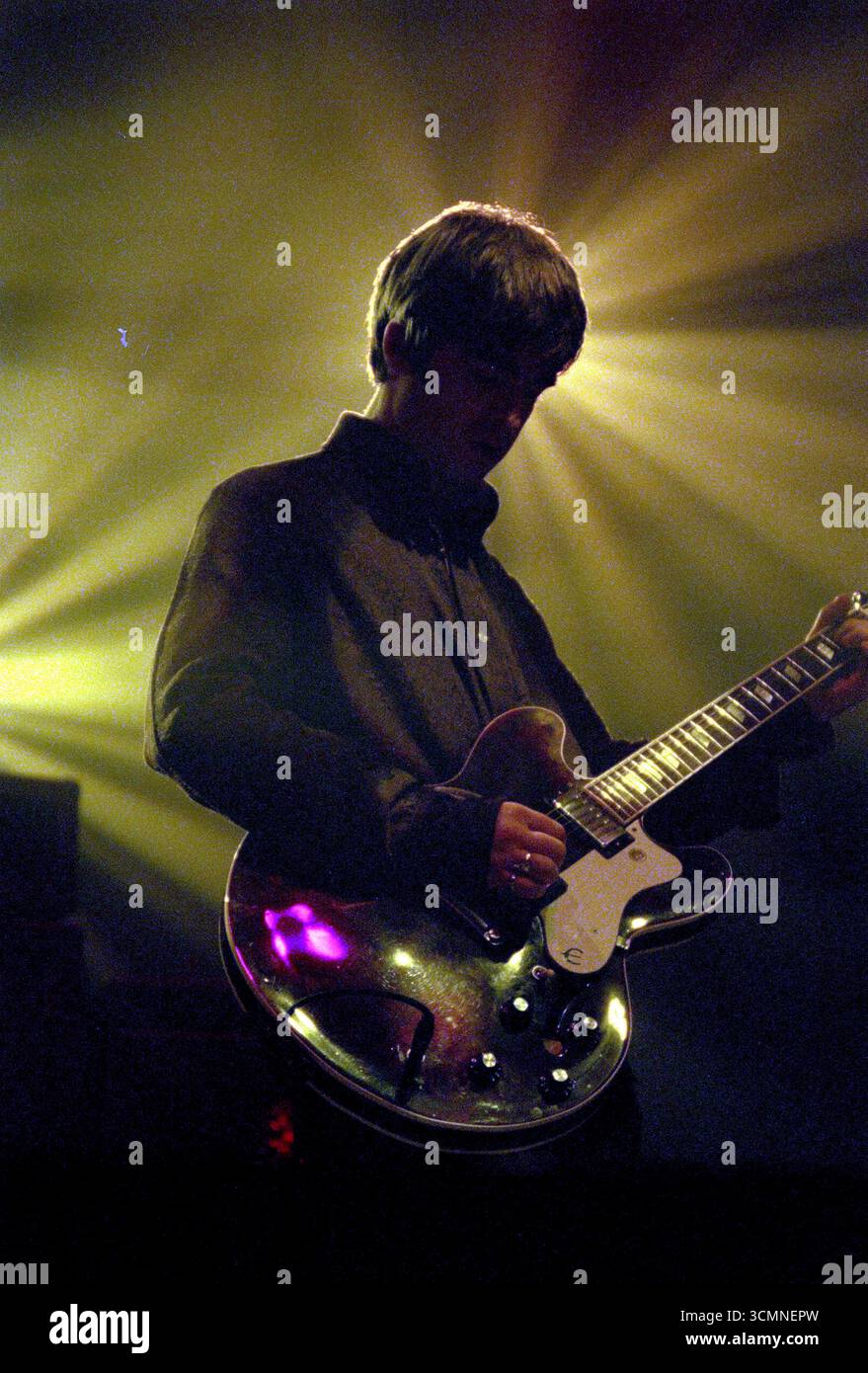 Guitarist Noel Gallagher with guitar on stage during the Oasis concert ...