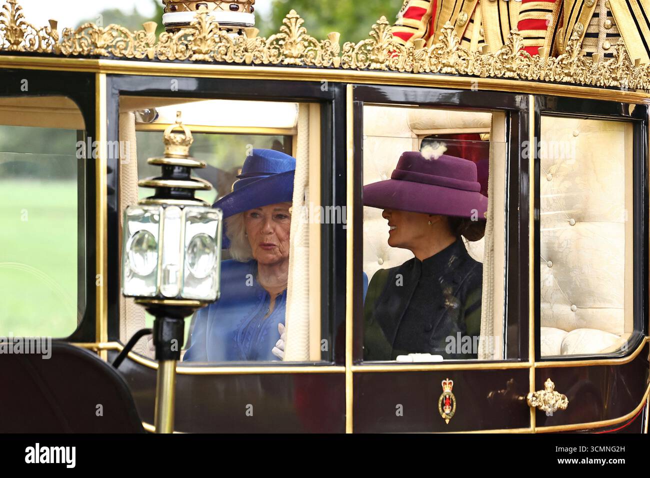 Britain's Queen Camilla, left, and first lady Melania Trump ride in the ...