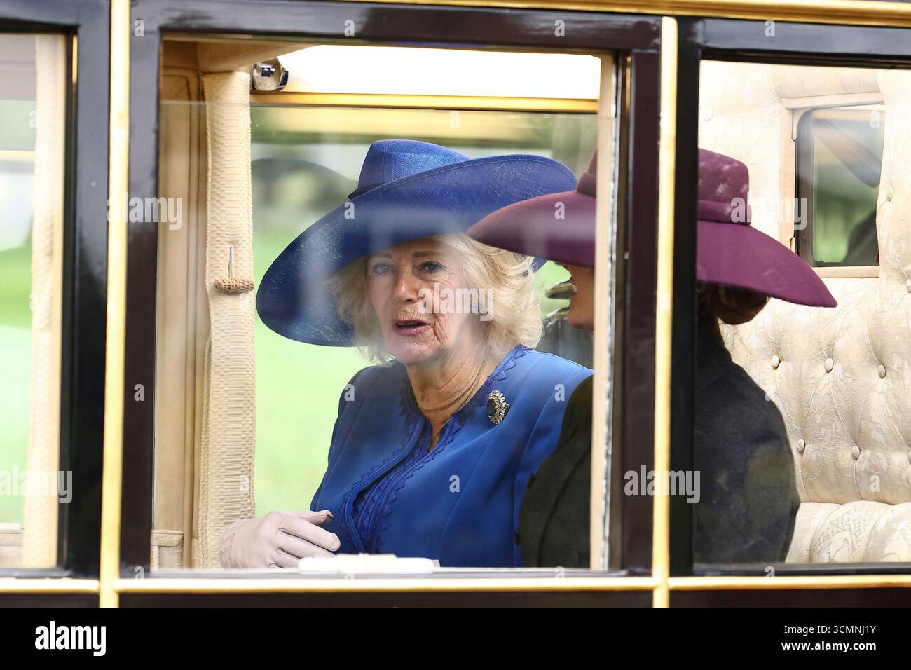 Britain's Queen Camilla, left, and first lady Melania Trump ride in the ...