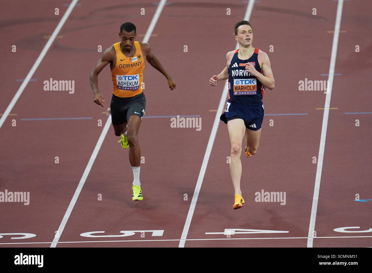 Germany's Emil Agyekum and Norway's Karsten Warholm cross the finish ...