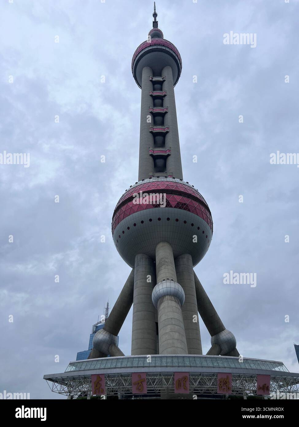 The Oriental Pearl Tower rises boldly against the cloudy Shanghai sky ...
