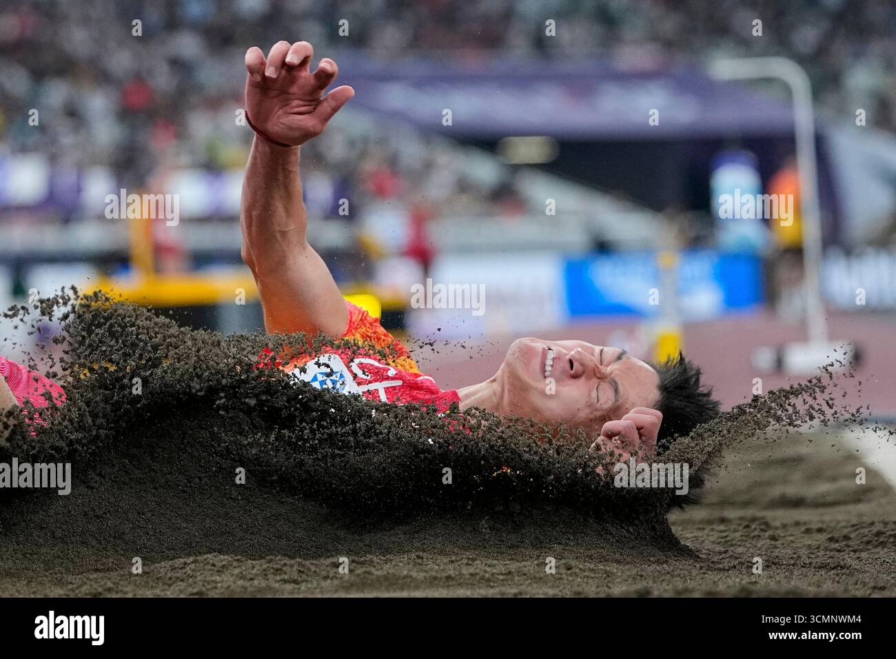 China's Zhang Mingkun competes in the men's long jump final at the ...