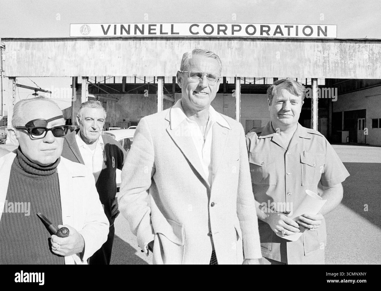 Members of Vinnell Corporation pose in front of their headquarters in ...