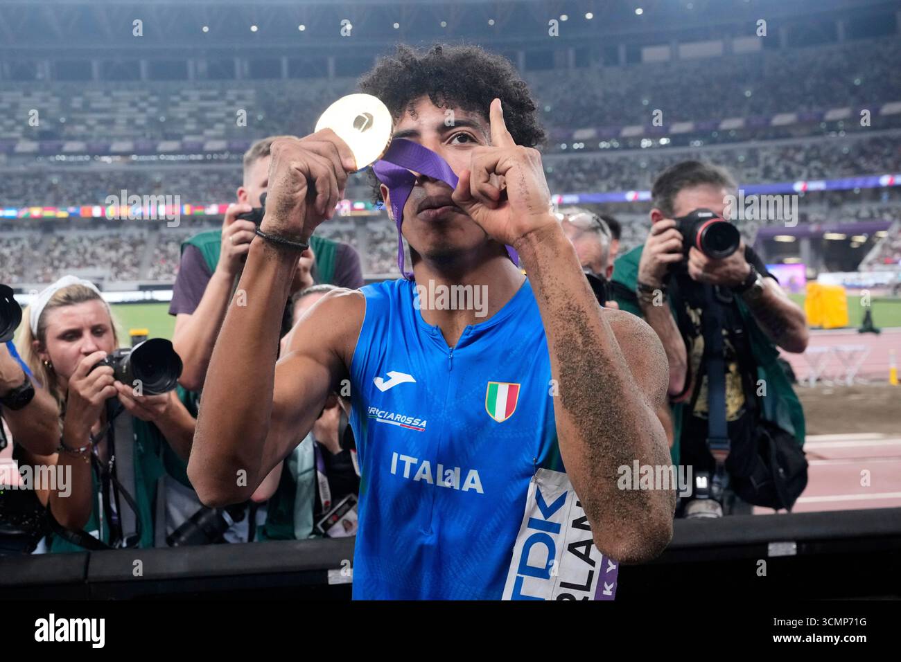Italy's Mattia Furlani reacts after taking the gold medal in the men's ...