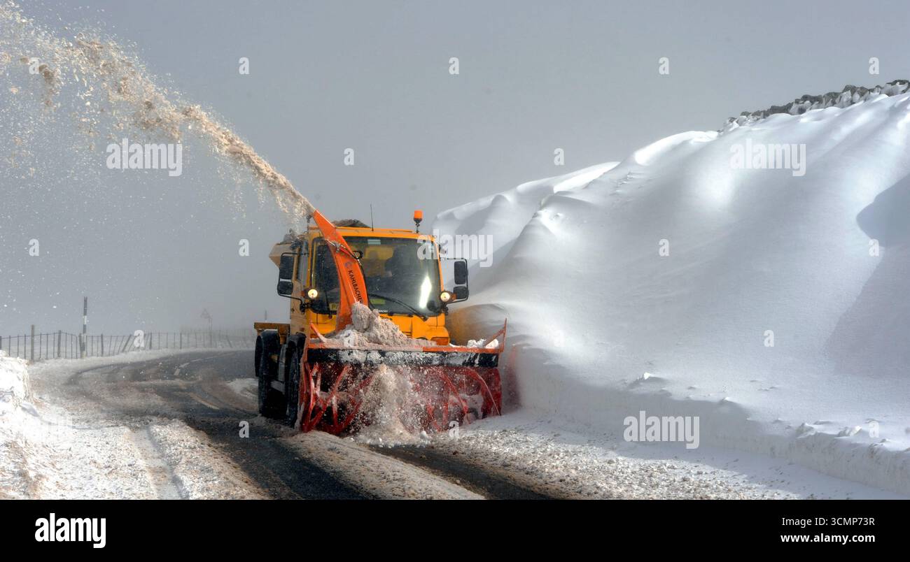 A Snow Blower makes its way through deep snow drifts in an attempt ...
