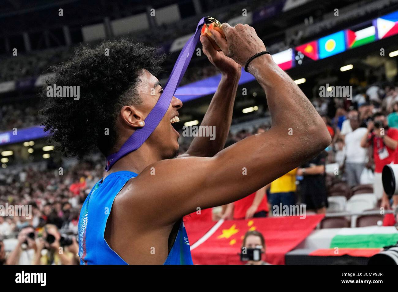 Italy's Mattia Furlani celebrates with his gold medal after winning the ...