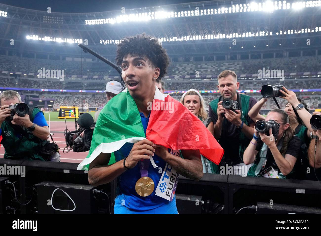 Italy's Mattia Furlani reacts after taking the gold medal in the men's ...