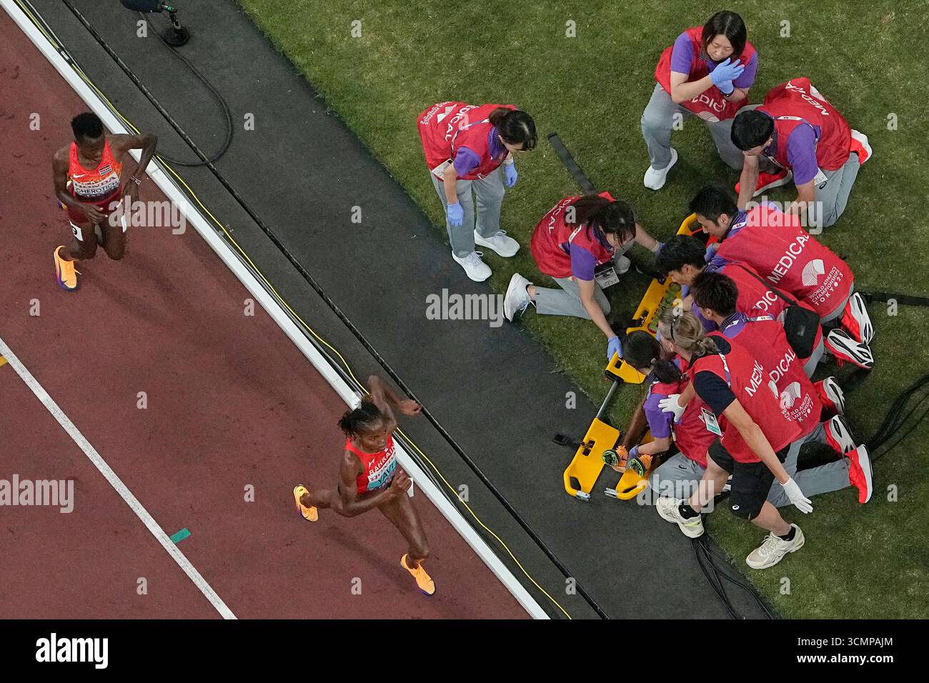 Uganda's Peruth Chemutai is helped by a medical team after falling during the women's 3,000 ...