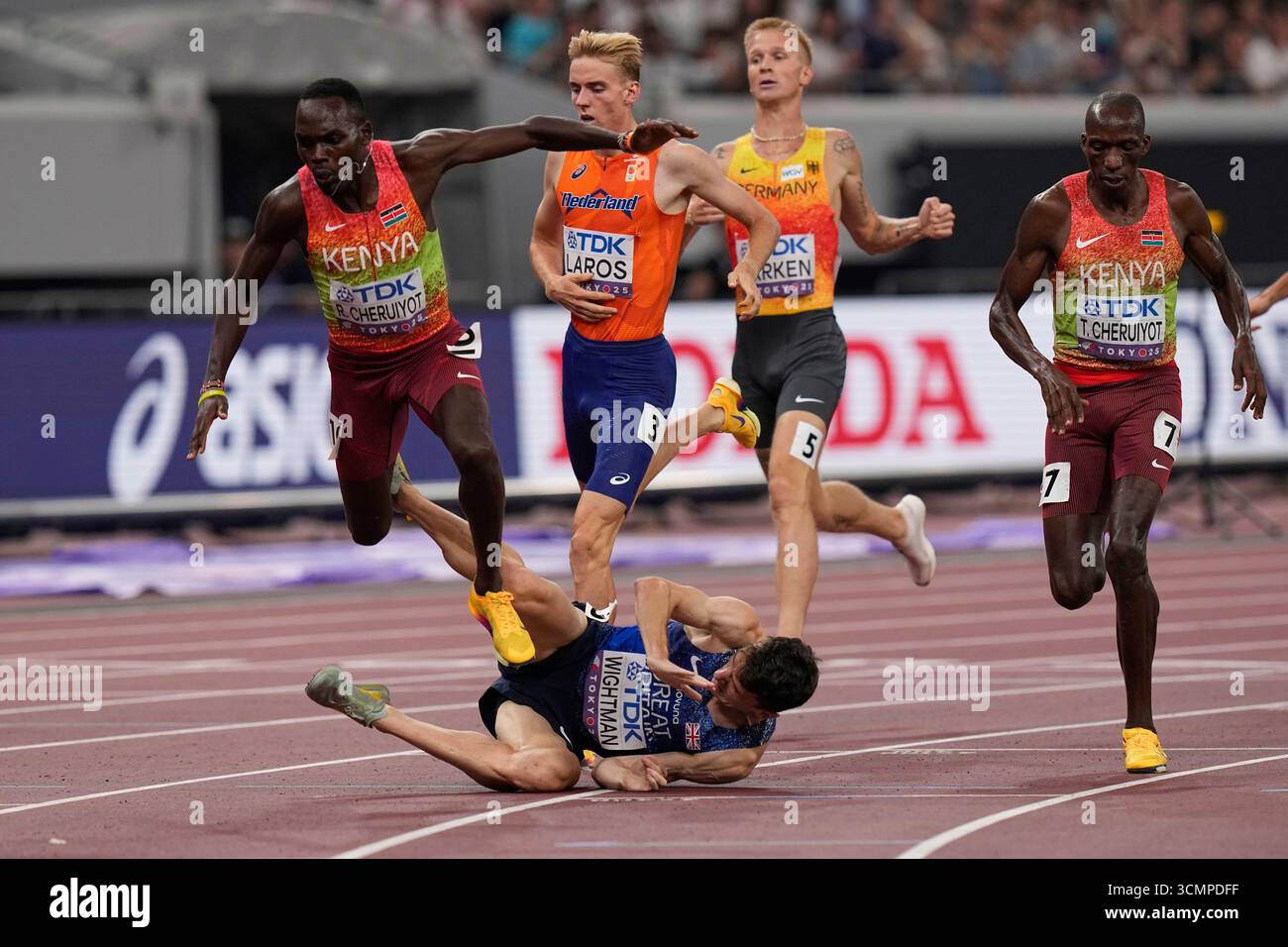 Britain's Jake Wightman falls on the track during the men's 1,500 ...
