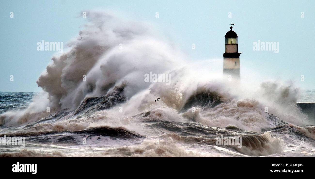 Huge waves batter the sea wall and lighthouse of Seaham Harbour on the ...