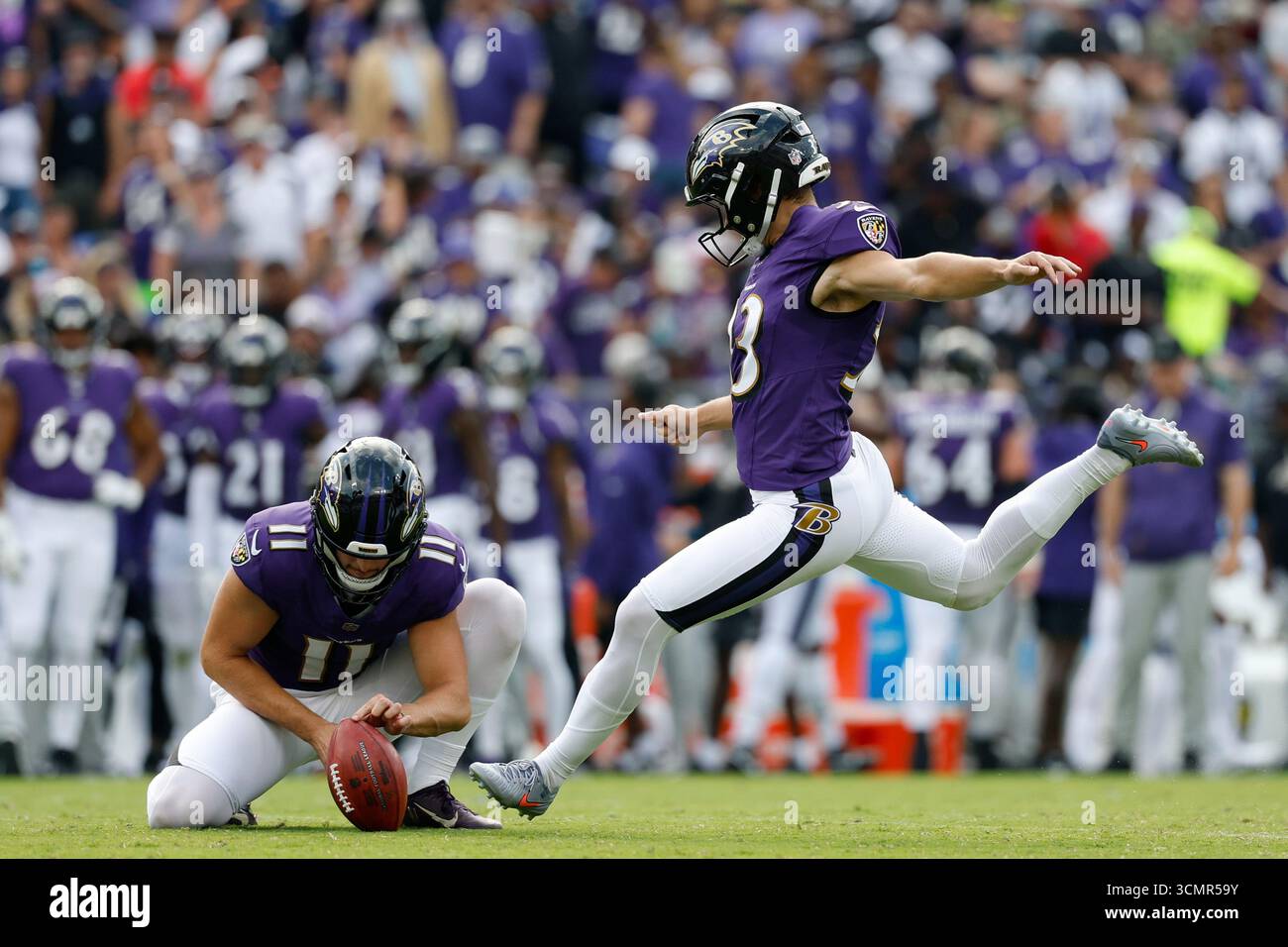 Baltimore Ravens place kicker Tyler Loop kicks a field goal as punter ...