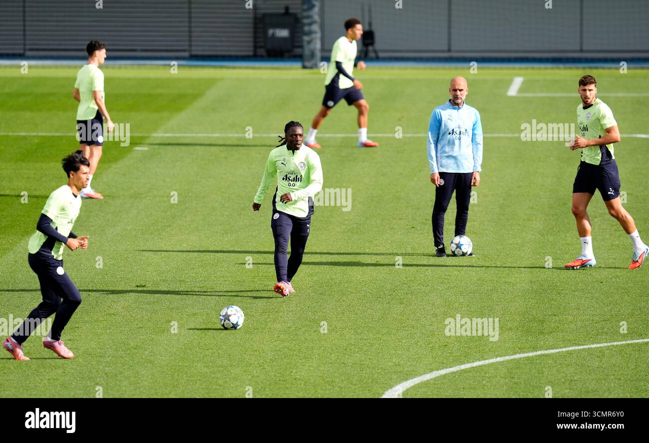 Manchester City's Jeremy Doku (centre) and players training as ...