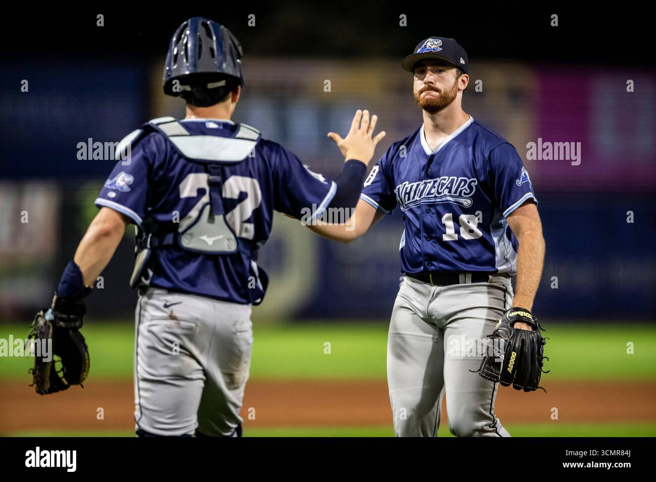 West Michigan' Whitecaps' Colin Fields, right, high-fives Bennett Lee ...