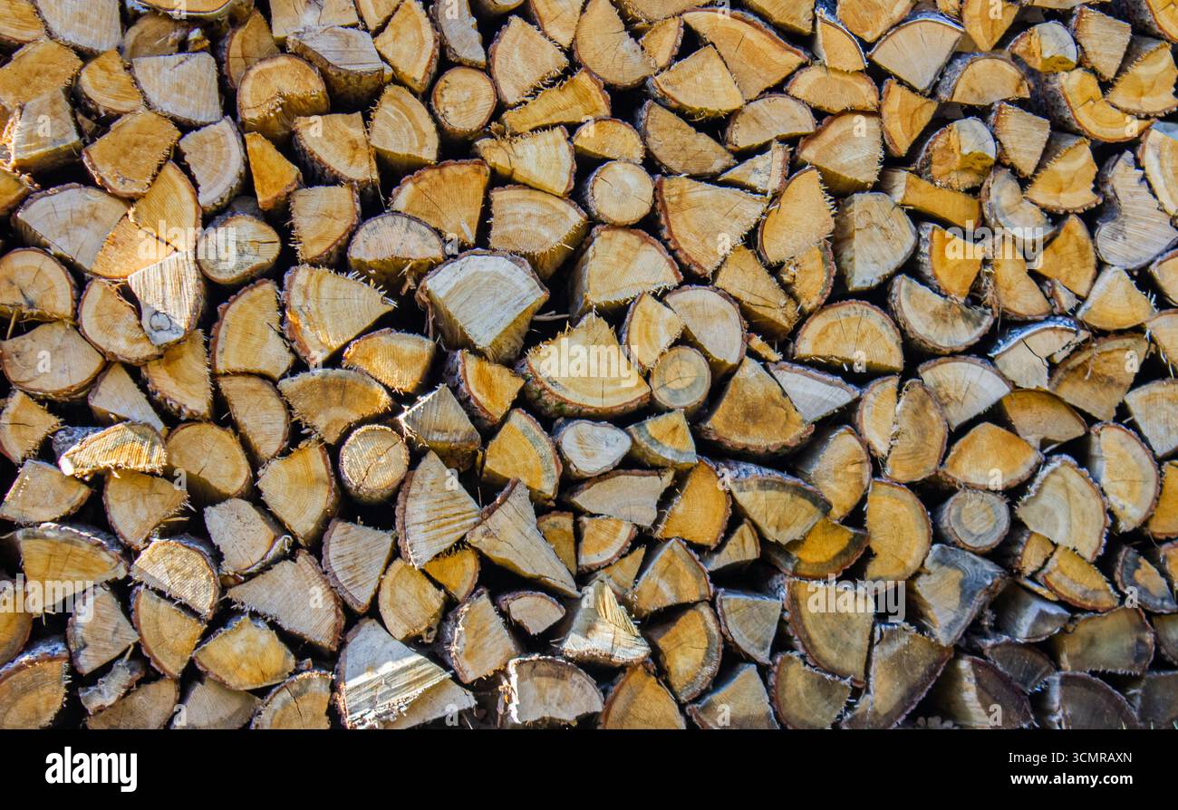 A Close-up view of Neatly stacked Firewood Logs, showcasing the natural ...