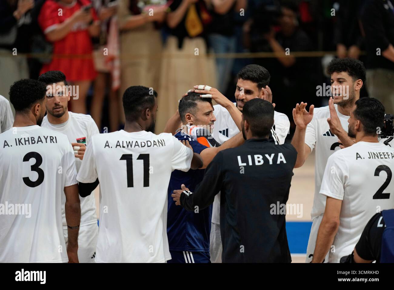 Foad Elmaarug of Libya walks beside his team as he retires after their ...
