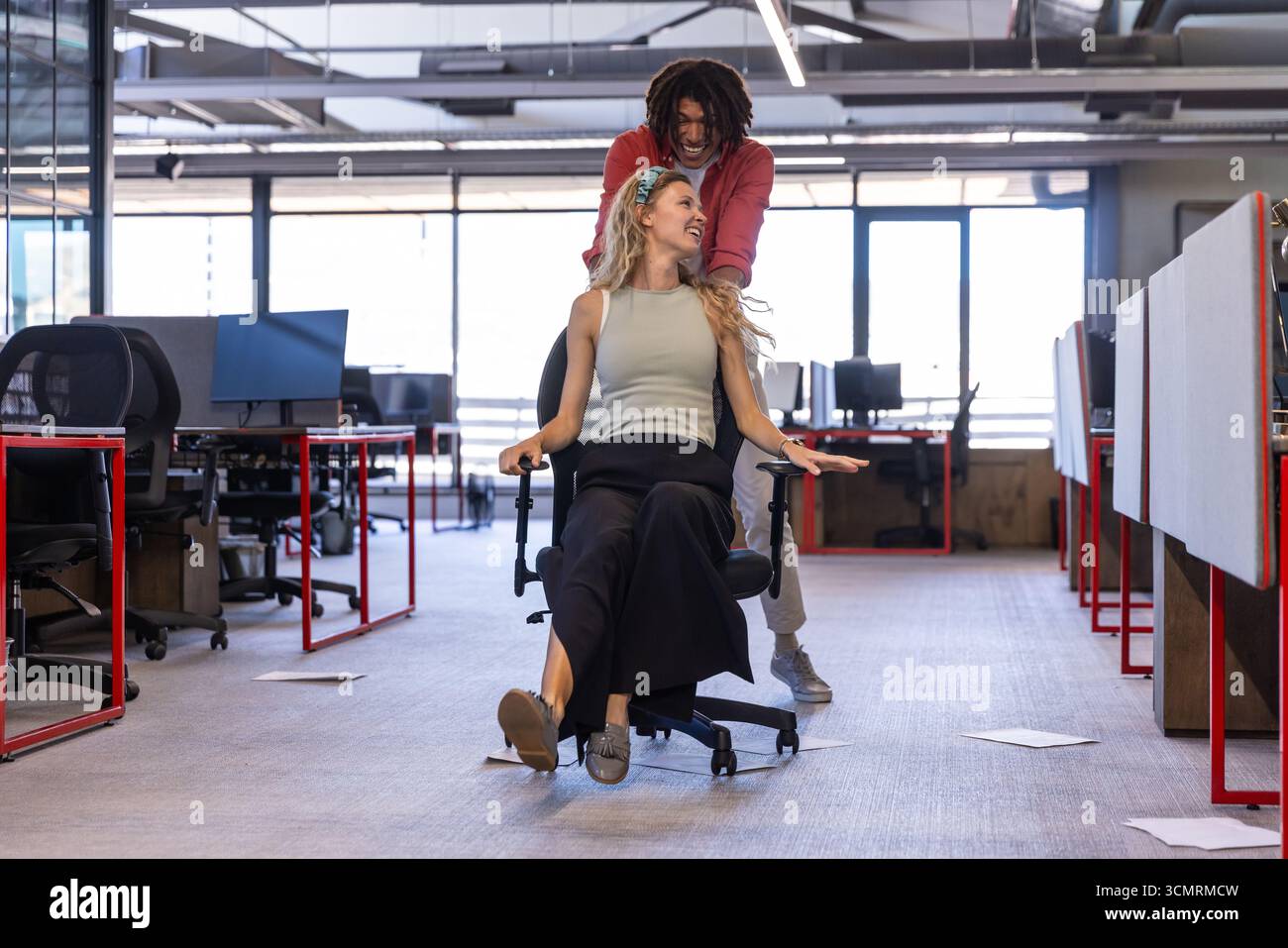Black office chair rolling down wide aisle in modern open plan ...
