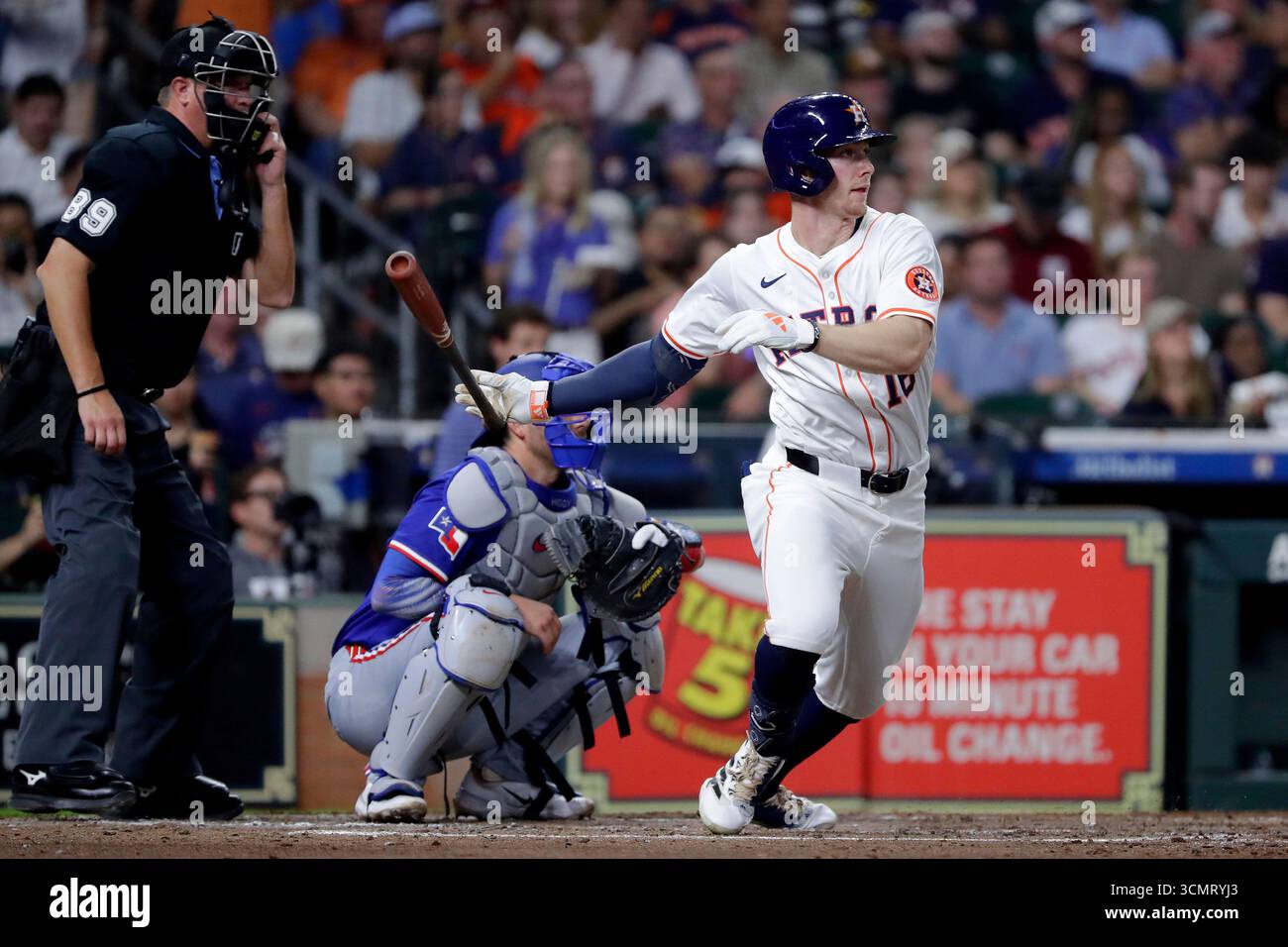 Houston Astros' Zachary Cole, right, watches his hit in front of Texas ...