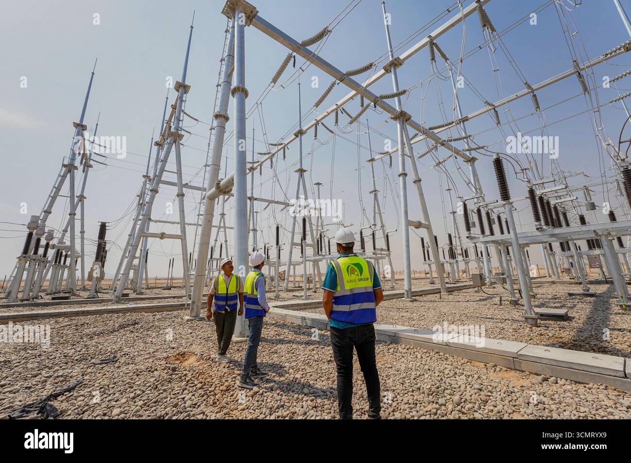 Workers stand at a newly opened industrial-scale solar power plant in ...