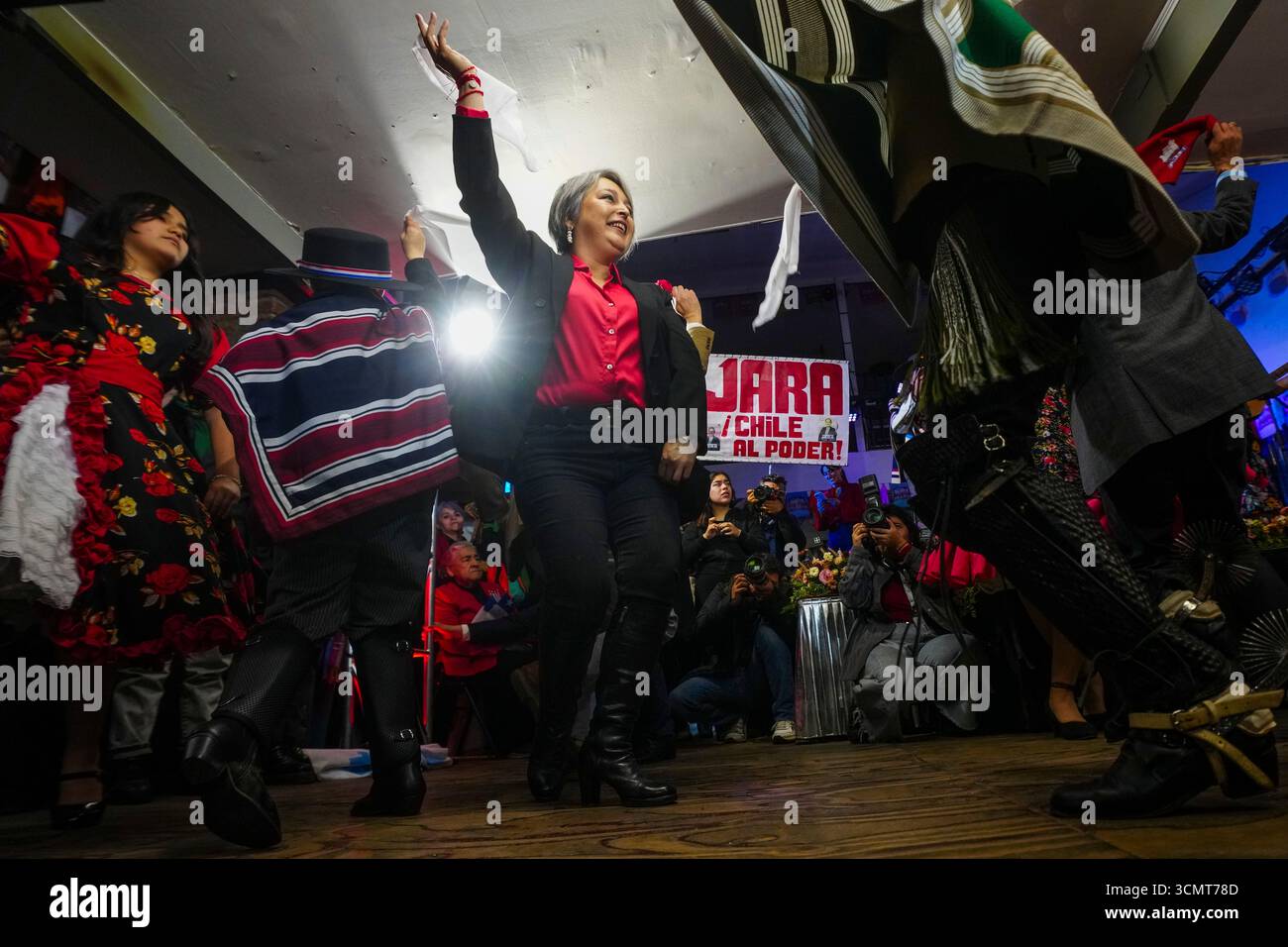 Presidential candidate Jeannette Jara, center, dances the traditional ...