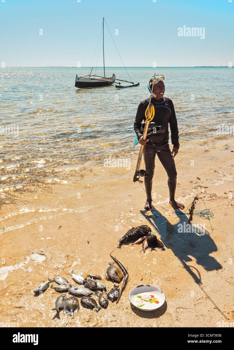 Man in black wetsuit spearfishing hi-res stock photography and images ...