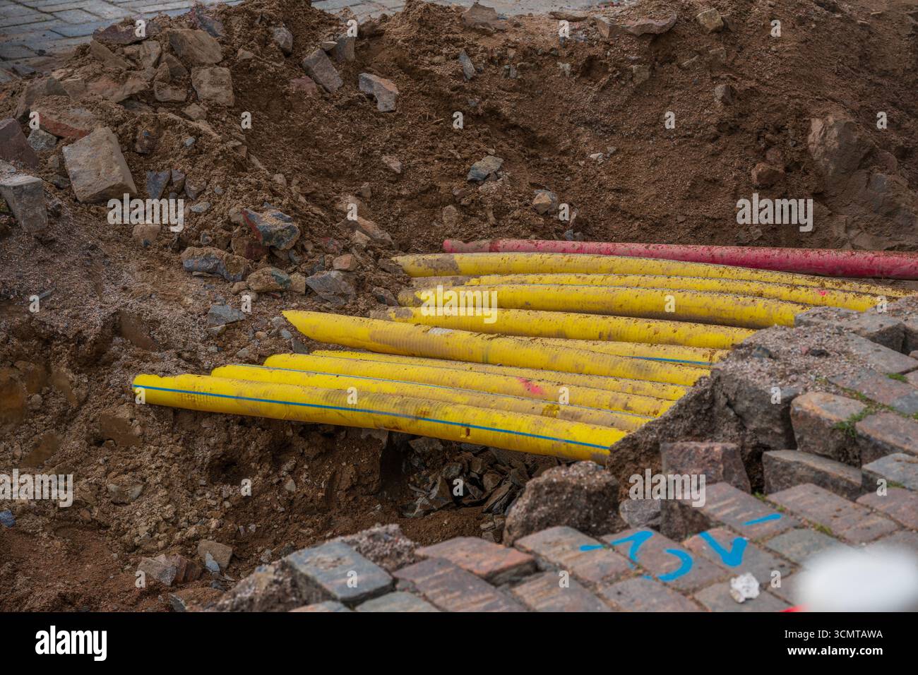 Construction site with exposed yellow underground utility pipes Stock ...