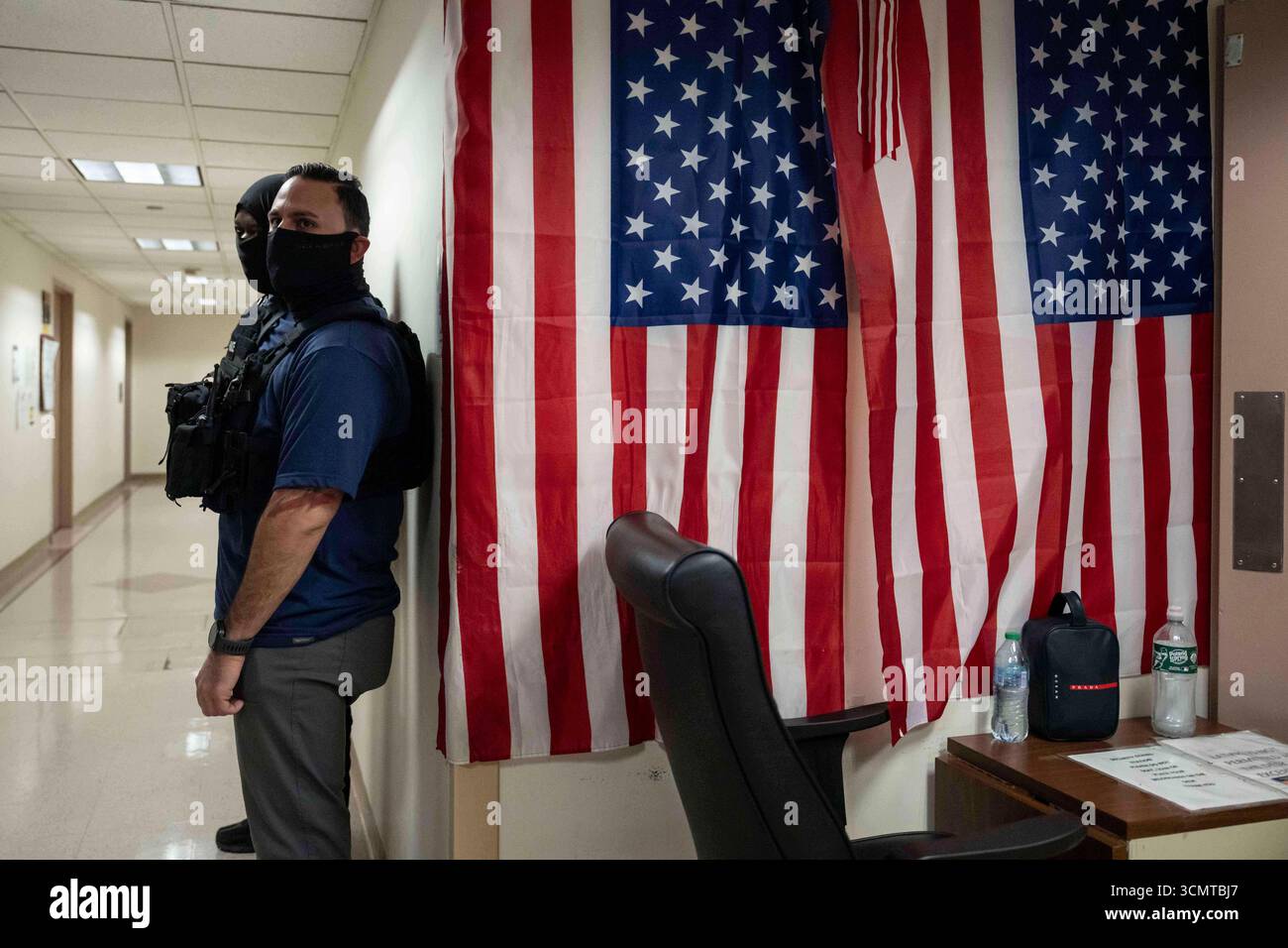 Federal agents stand outside an immigration court at the Jacob K ...
