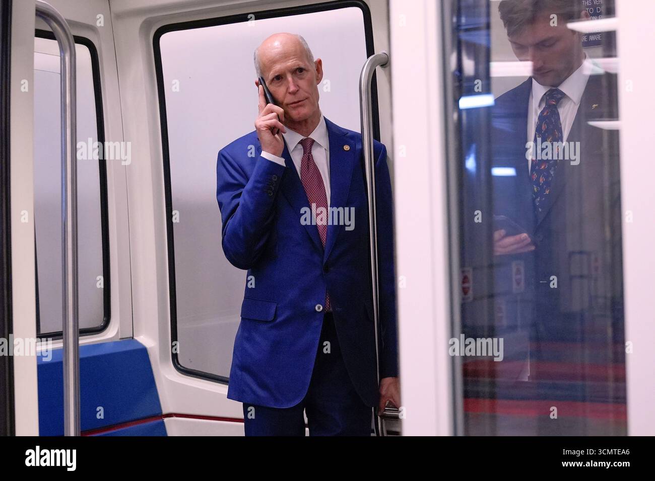 Sen. Rick Scott, R-Fla., left, talk on the phone at the Capitol subway ...