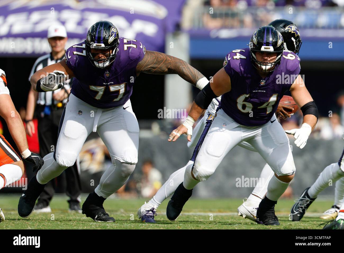 Baltimore Ravens guard Daniel Faalele (77) and center Tyler Linderbaum ...
