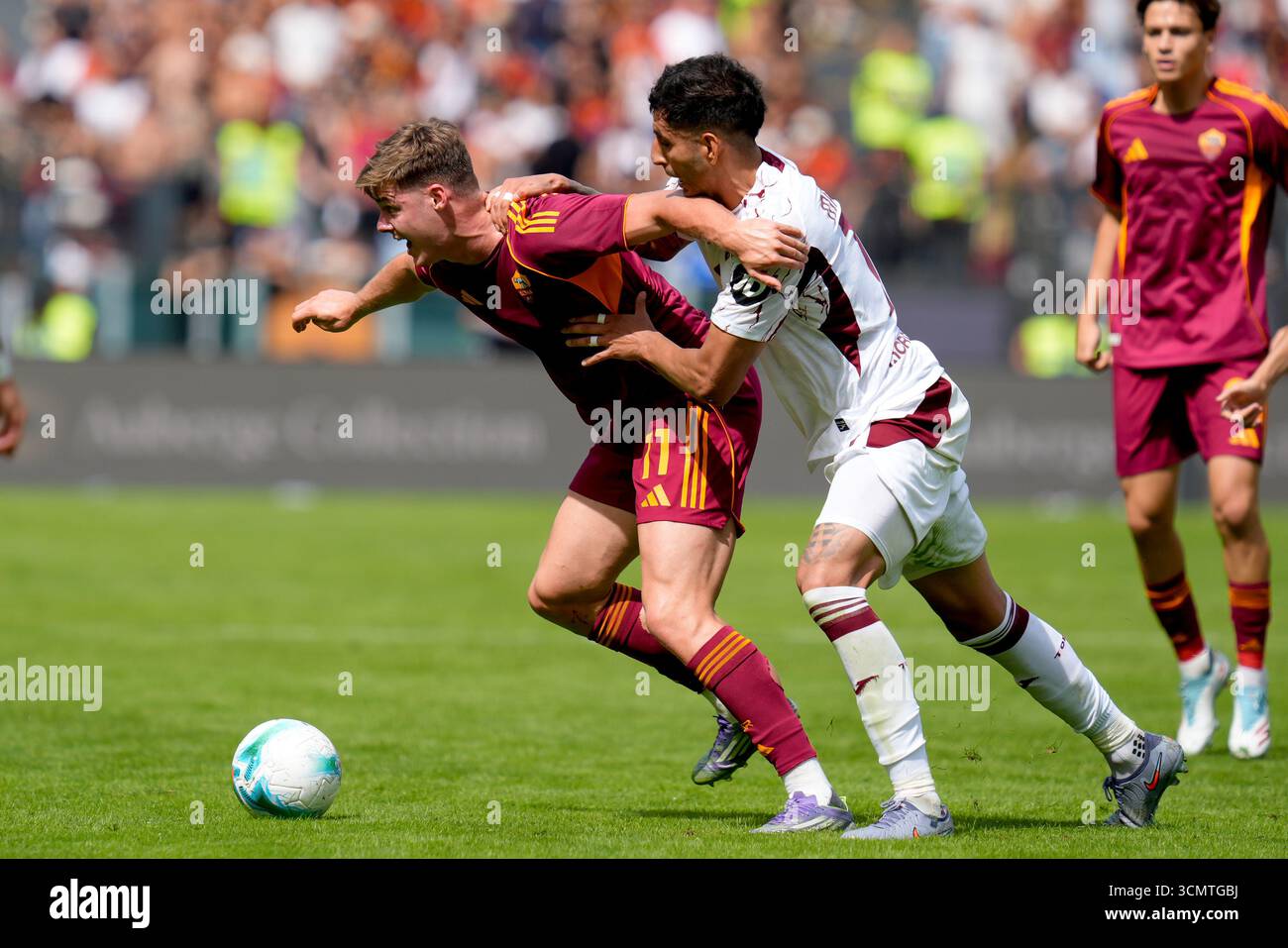 Evan Ferguson of AS Roma and Guillermo Maripan of Torino FC compete for ...