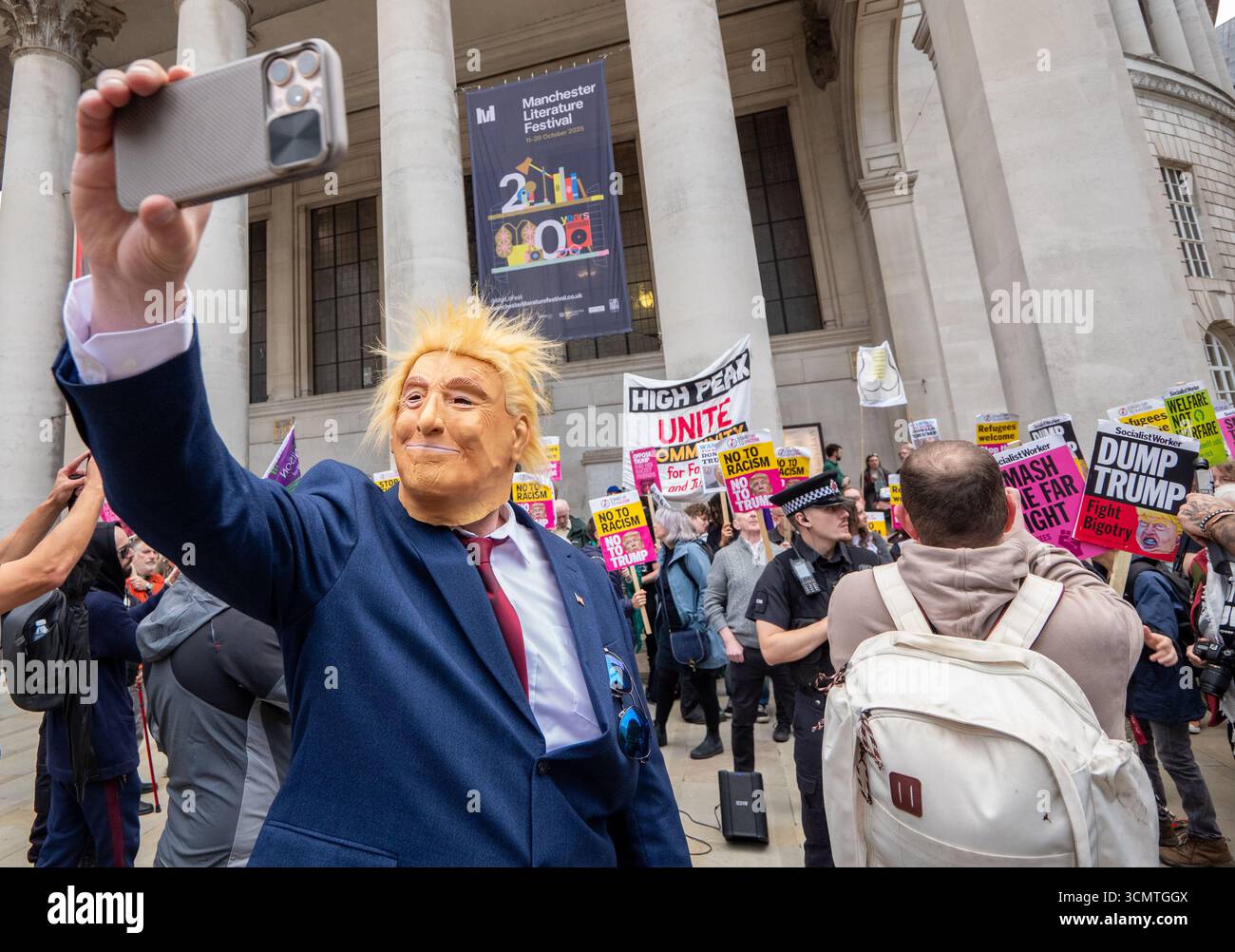 Man in Donald Trump mask takes selfie at Protest. Anti trump supporters ...