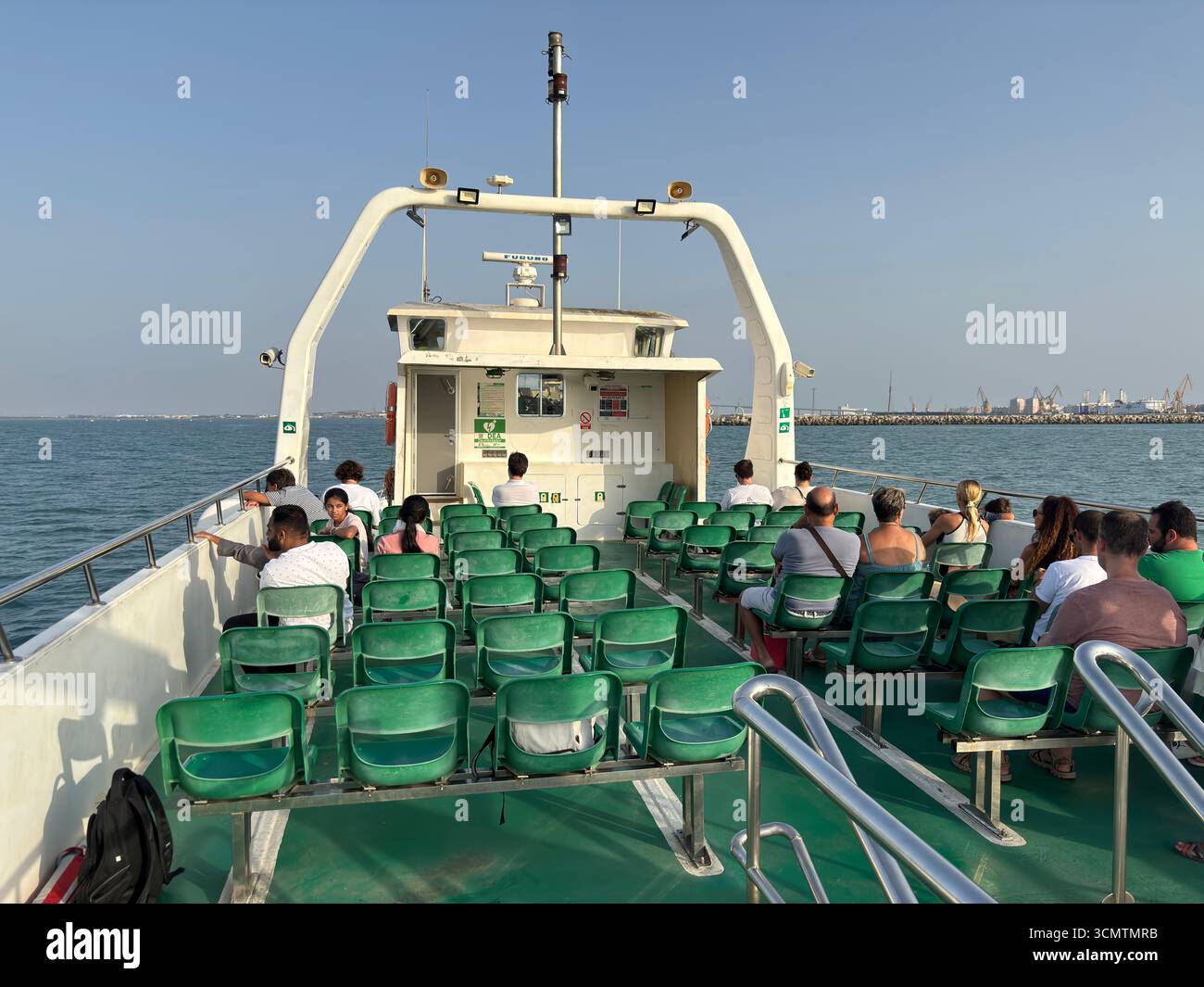 Seat rows and cabin walkways inside a ferry in Spain, windows ...