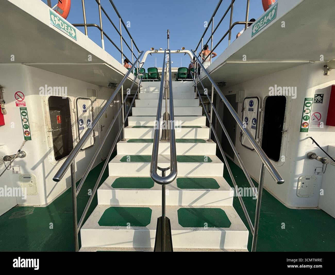 Seat rows and cabin walkways inside a ferry in Spain, windows ...