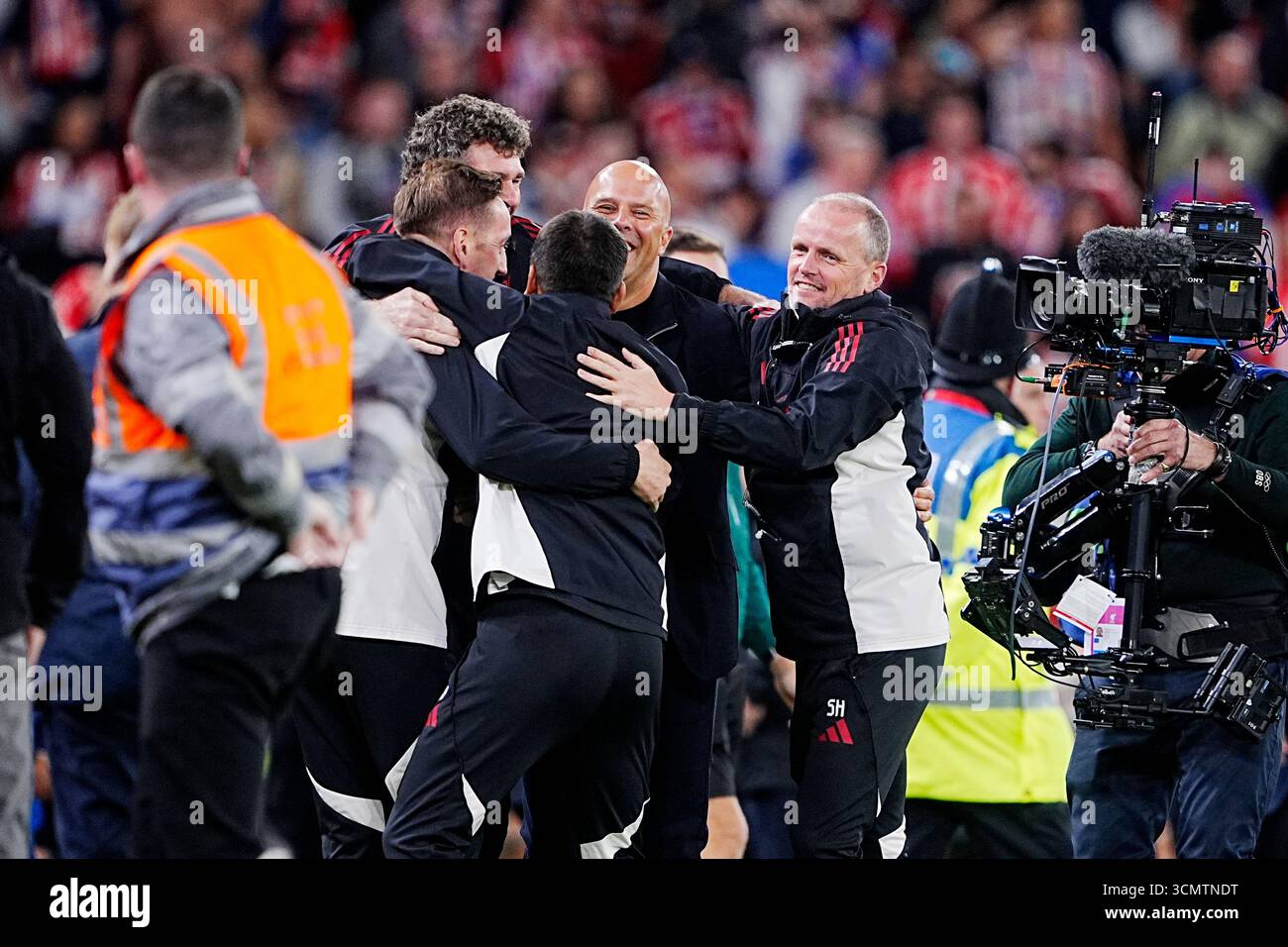 Liverpool manager Arne Slot celebrates with his staff after the UEFA ...