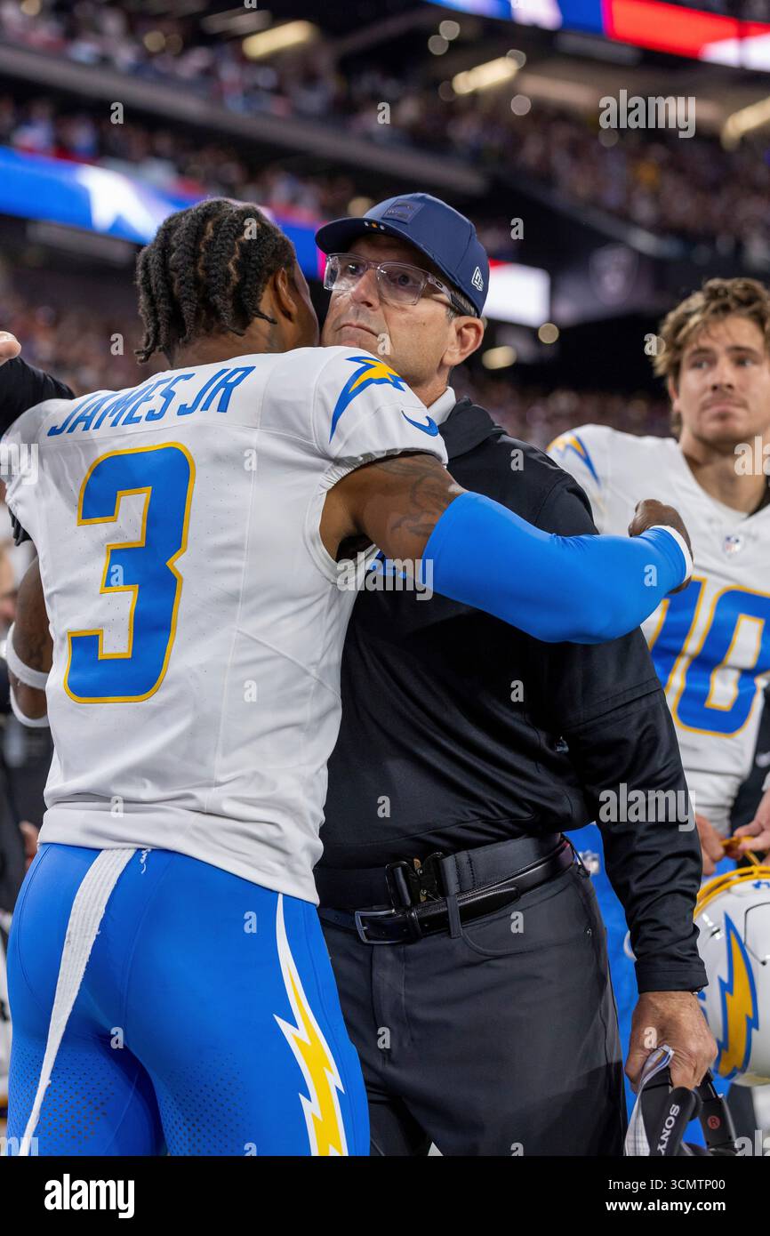 Los Angeles Chargers head coach Jim Harbaugh receives a hug from Derwin ...