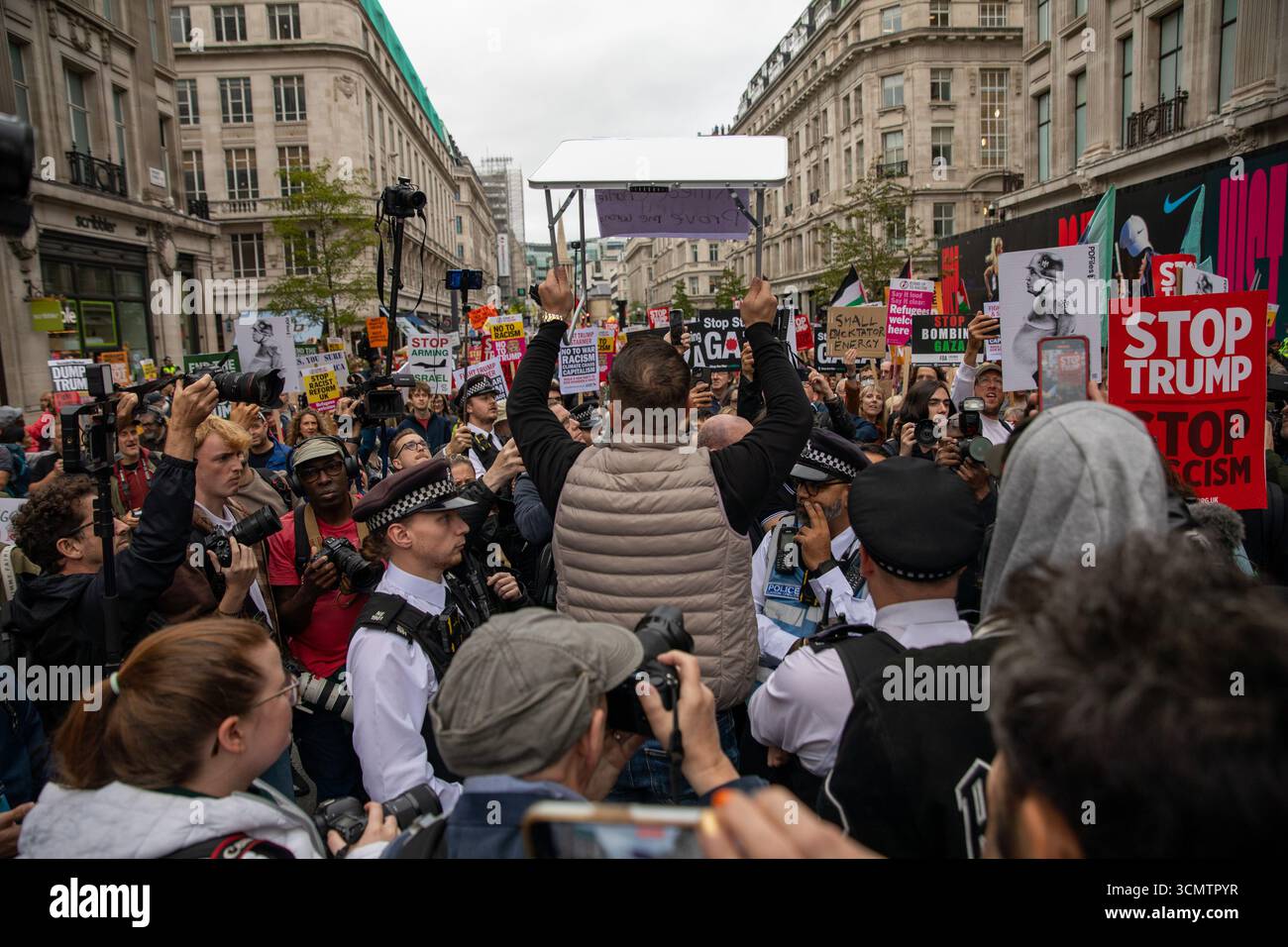 A right wing activist is surrounded by Police and journalists during a ...