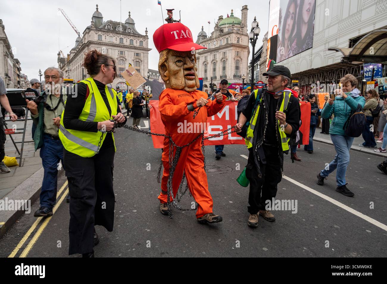A protestor dressed as Donald Trump in a prison suite and chains at the ...