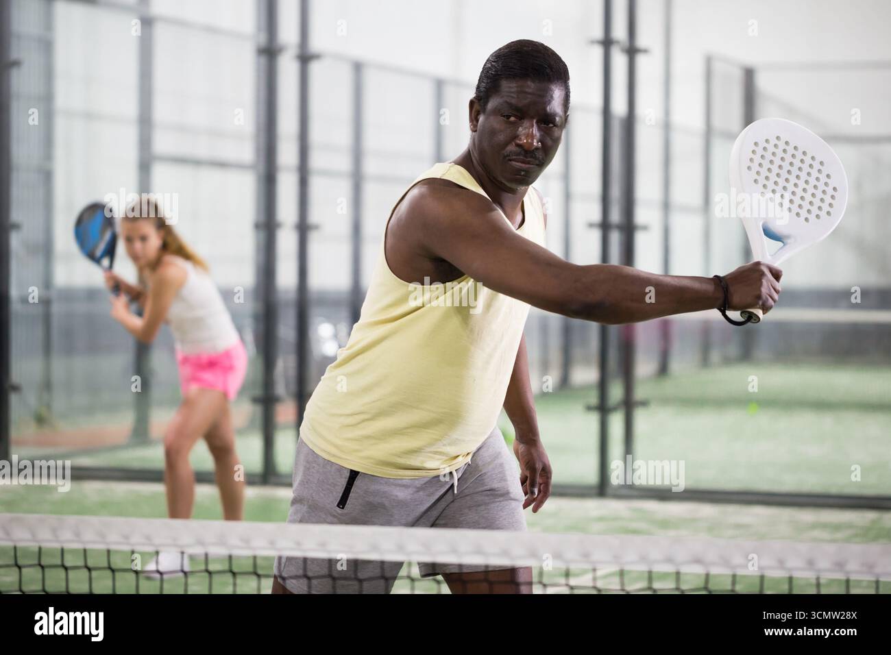 African American hitting backhand during paddle match in close court ...