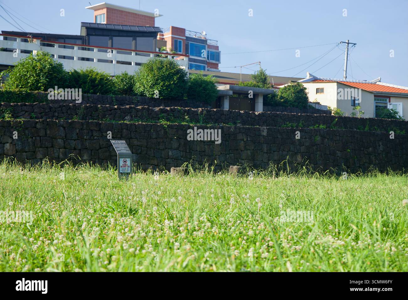 Stone rampart walls from the historic Seogwi Fortress rise above a ...
