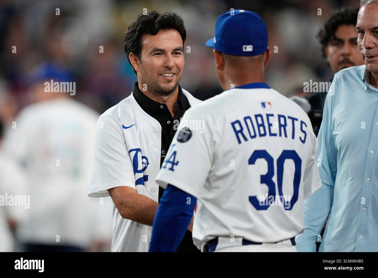 Cadillac Formula 1 driver Sergio Perez, left, speaks with Los Angeles ...