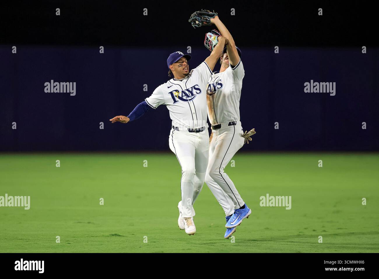 Tampa Bay Rays shortstop Carson Williams, right, makes a catch over ...