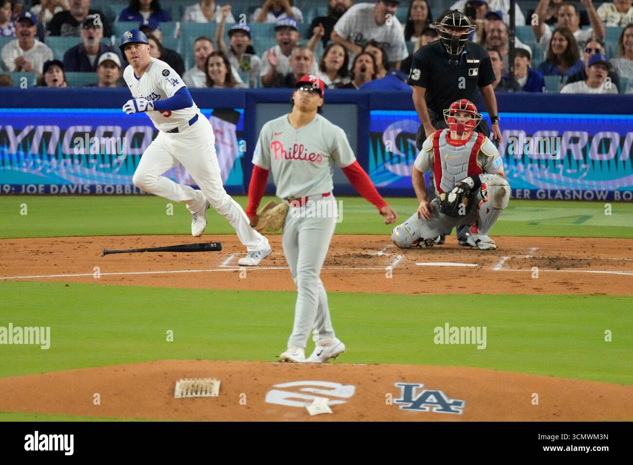 Los Angeles Dodgers' Freddie Freeman, left, watches his home run along ...