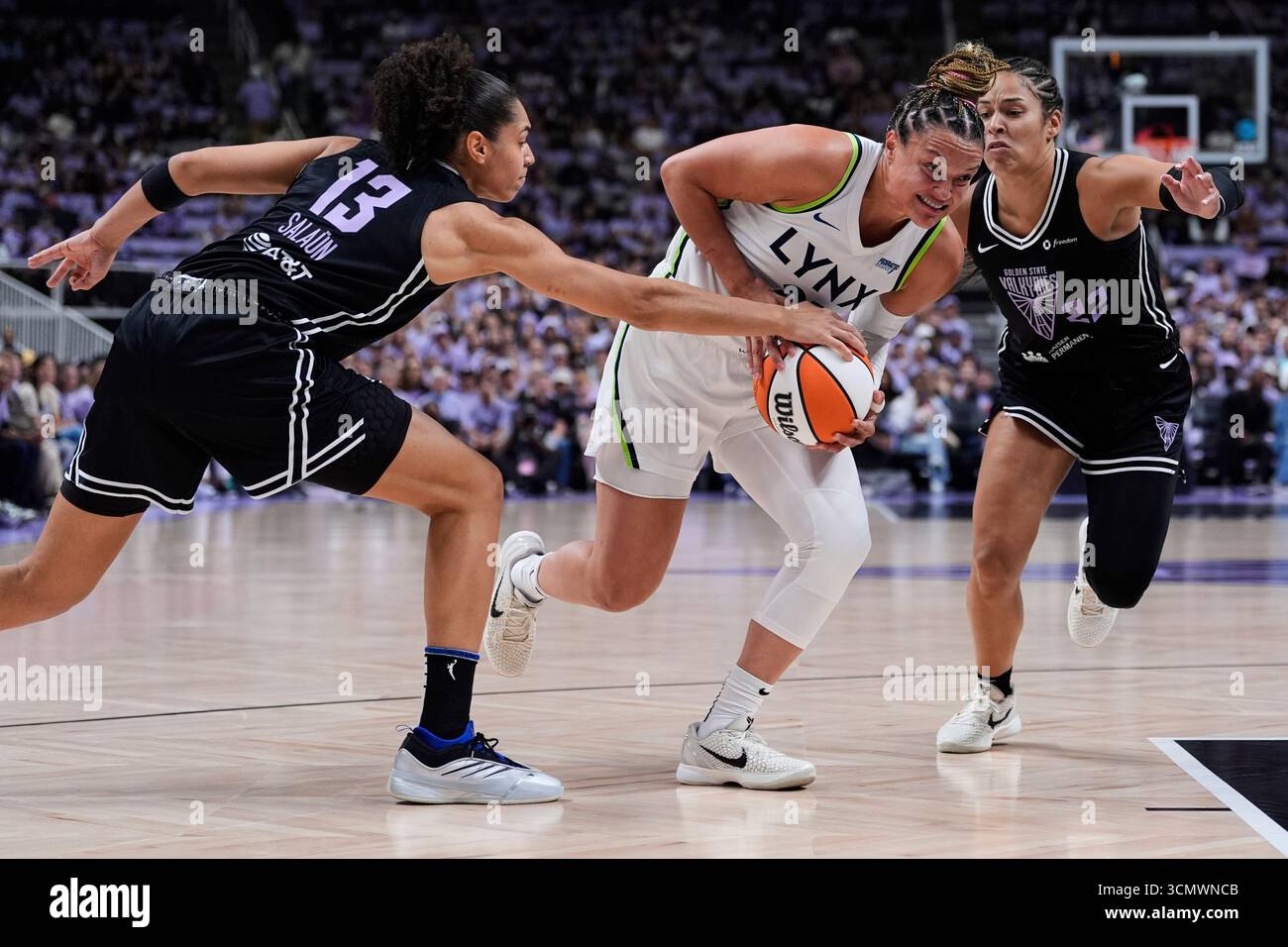 Minnesota Lynx guard Kayla McBride, center, moves the ball between ...