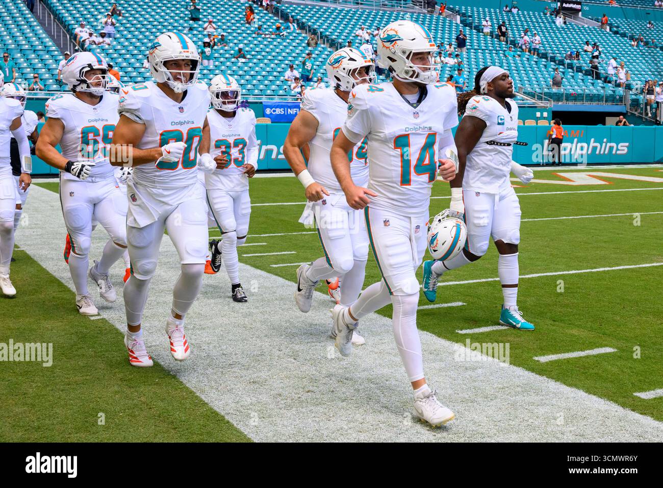Miami Dolphins quarterback Quinn Ewers (14), offensive lineman Daniel ...